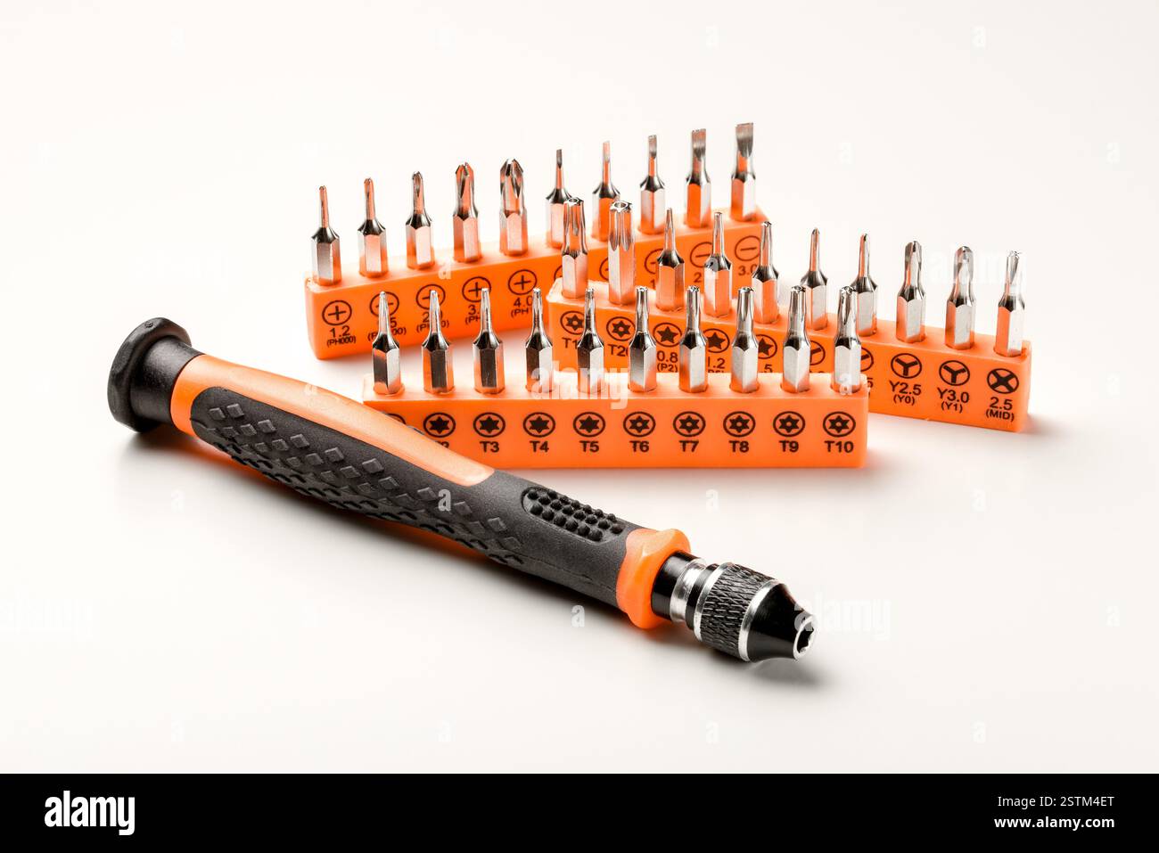Set of magnetic precision screwdriver bits with black and orange handle ...