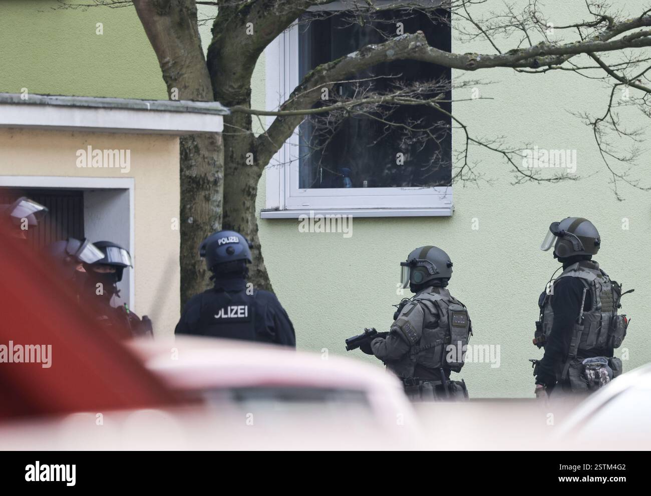 Cologne, Germany. 19th Feb, 2025. Police officers search a residential ...