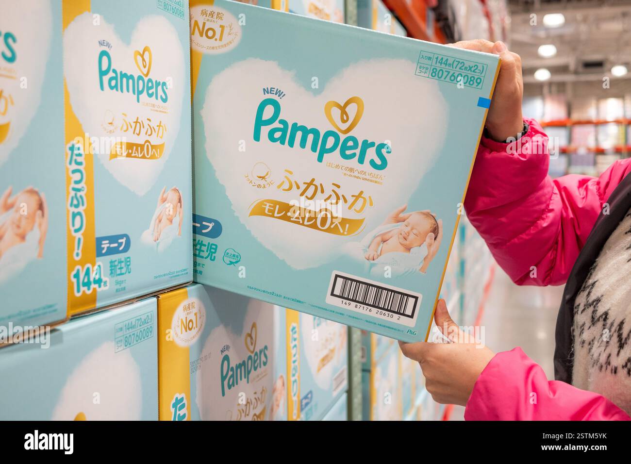 A mother's hand grabs a box of Pampers diapers Stock Photo - Alamy