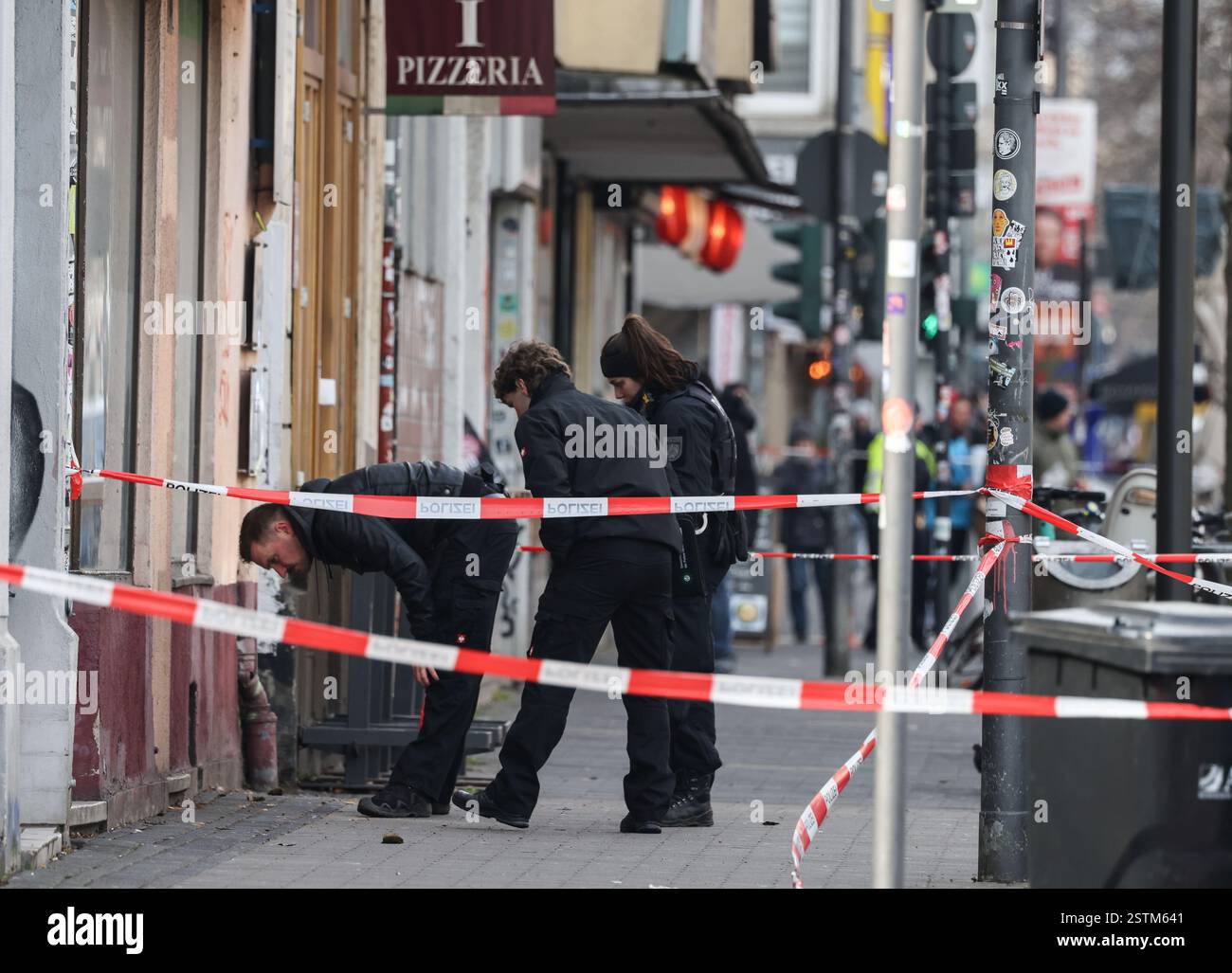 Cologne, Germany. 19th Feb, 2025. Police officers search for evidence ...