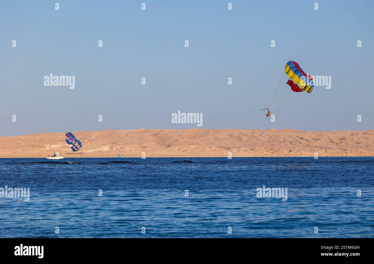 motorboat with parachute flying with a person over the water of the Red ...