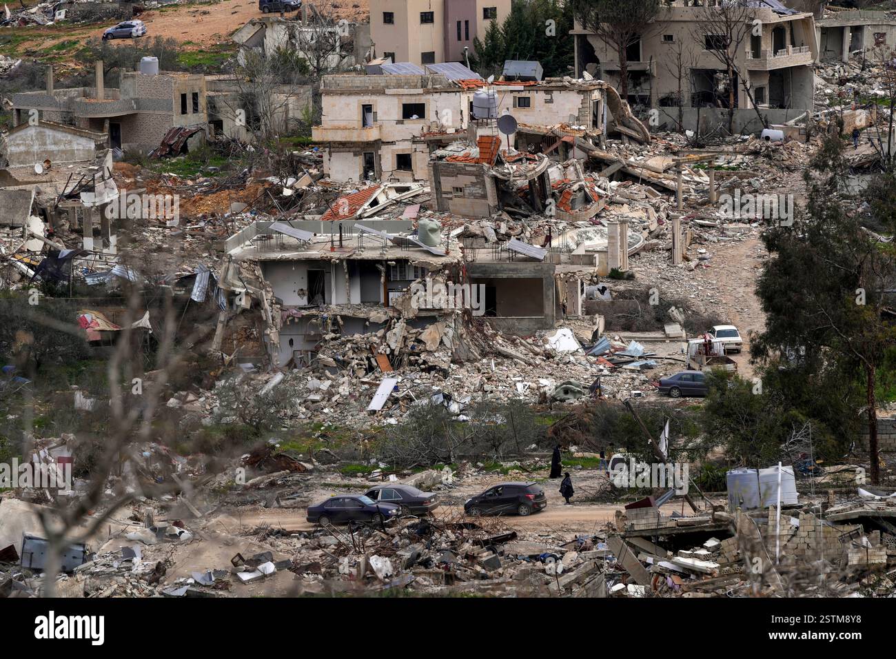 Lebanese citizens check the destruction in their village caused by the ...