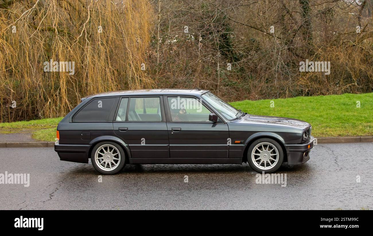 Milton Keynes,UK - Feb. 16th 2025: 1994 BMW 316 estate car driving on a ...