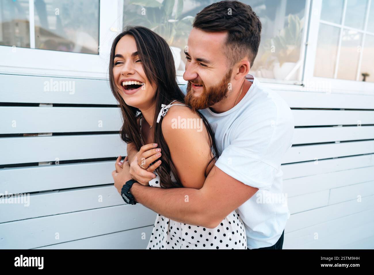 Handsome bearded man hugging his beautiful girl Stock Photo - Alamy