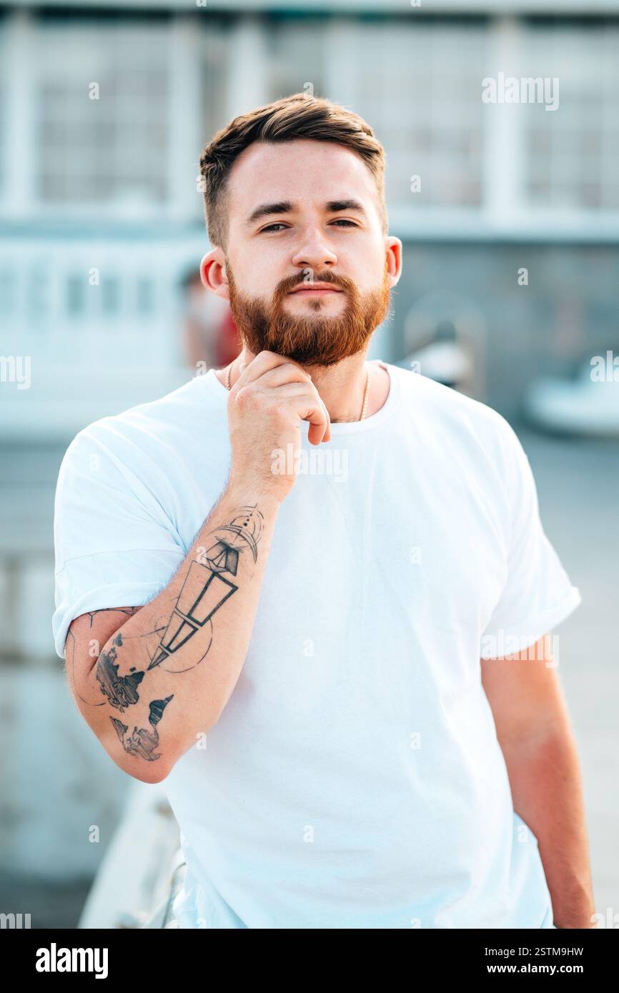 The bearded guy rubs his beard on the street Stock Photo - Alamy