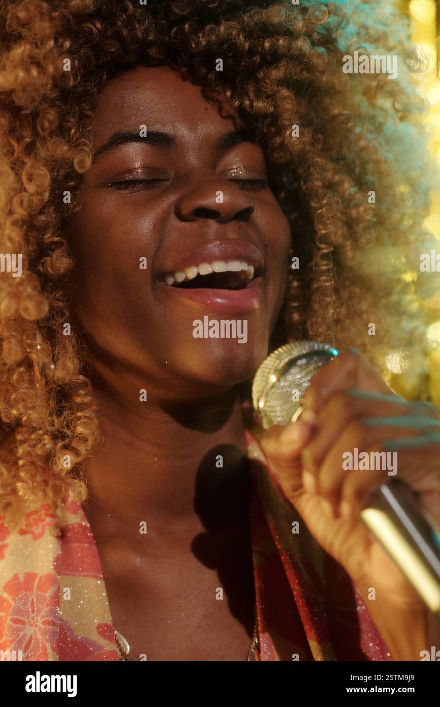 Singing Joyfully in Bright Stage Lighting Stock Photo - Alamy