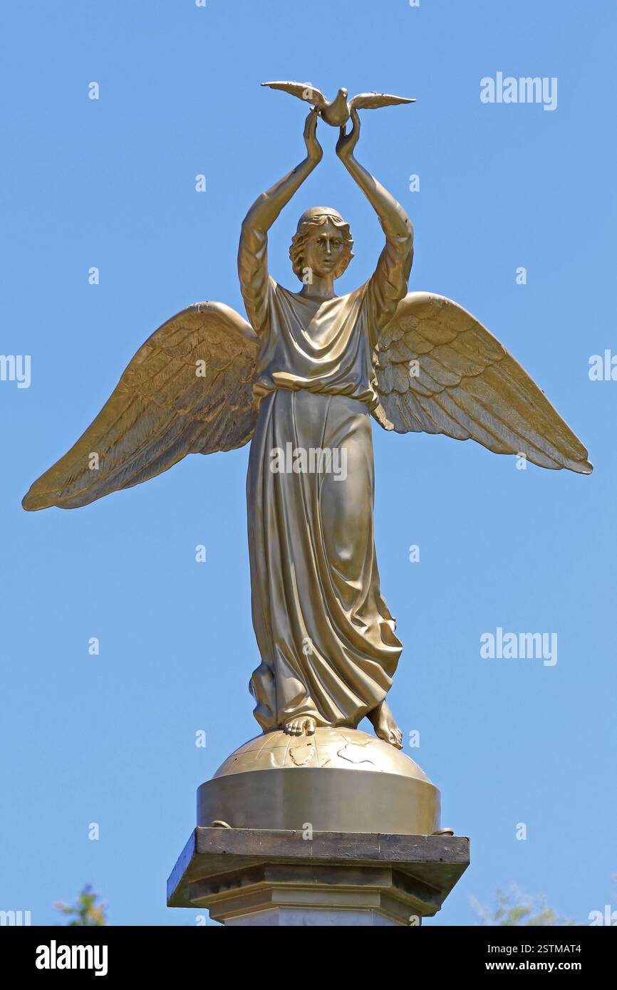 Winged gold lady holding dove statue in stratoni hi-res stock ...