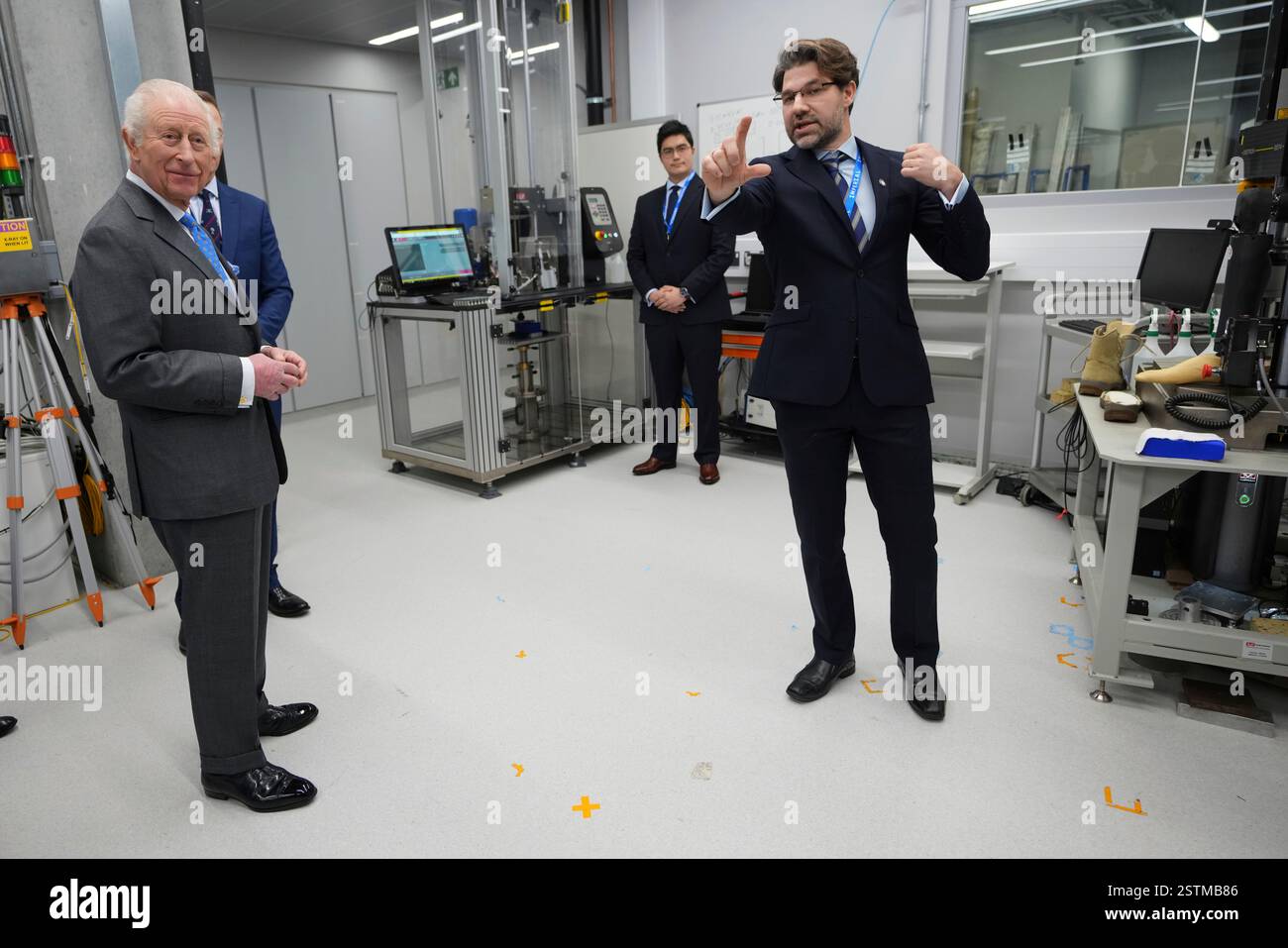 Britain's King Charles III is shown around a laboratory by researcher ...