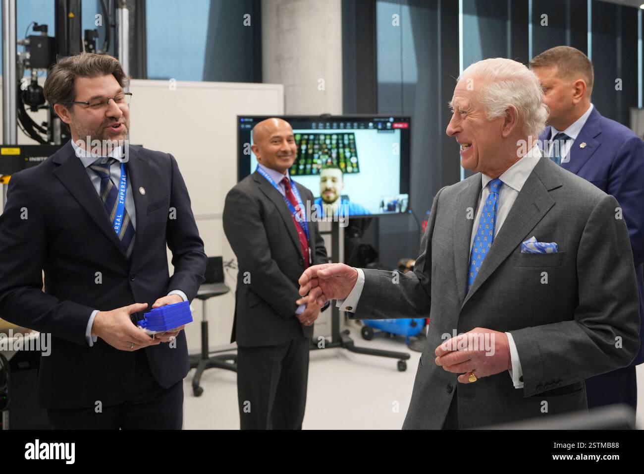 Britain's King Charles III is shown around a laboratory by researcher ...