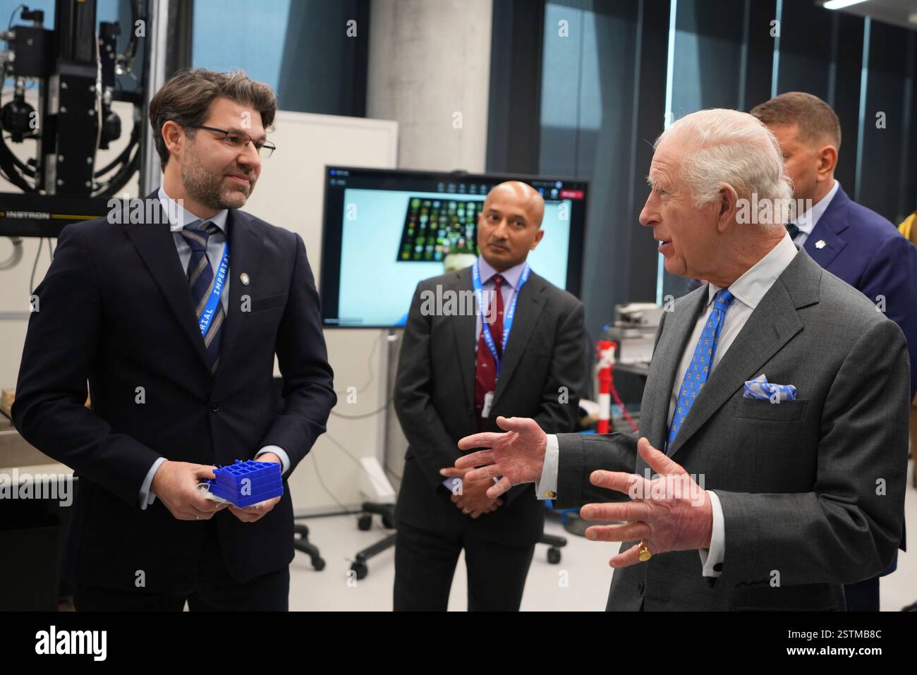 Britain's King Charles III is shown around a laboratory by researcher ...