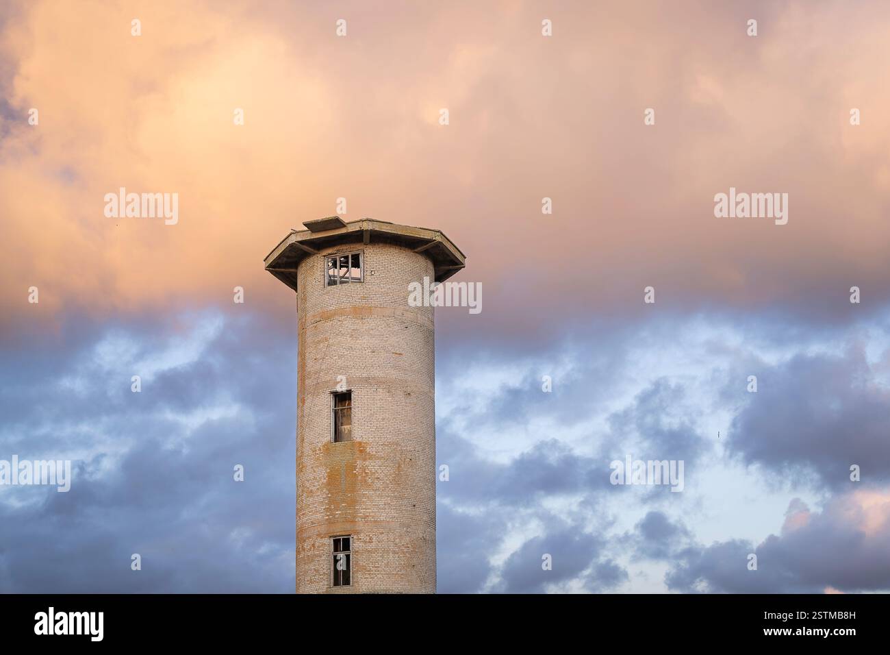 Exterior of abandoned fish factory water tower building. Old abandoned ...