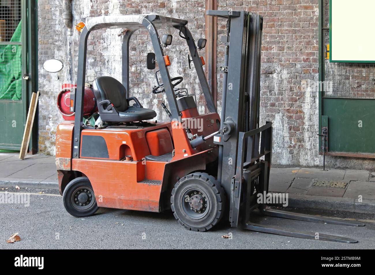 Gas powered forklift truck in front of warehouse hi-res stock ...