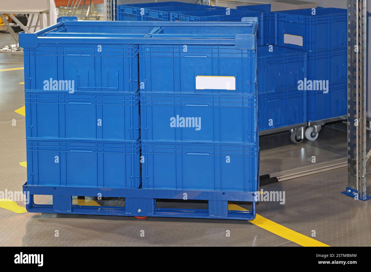 Blue plastic boxes at pallet cart in storage room hi-res stock ...