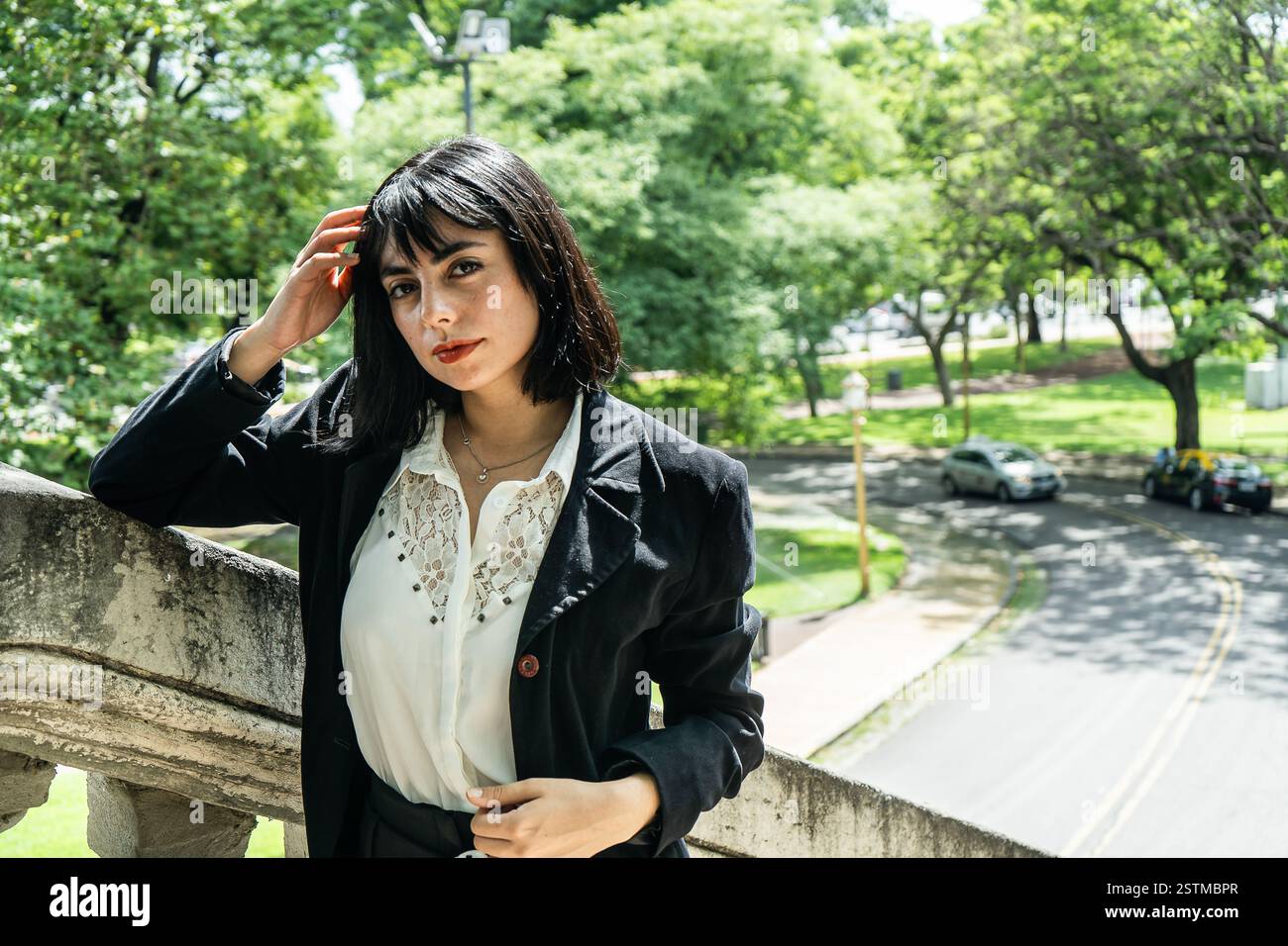 Elegant hispanic woman posing in a park wearing formal clothes Stock ...