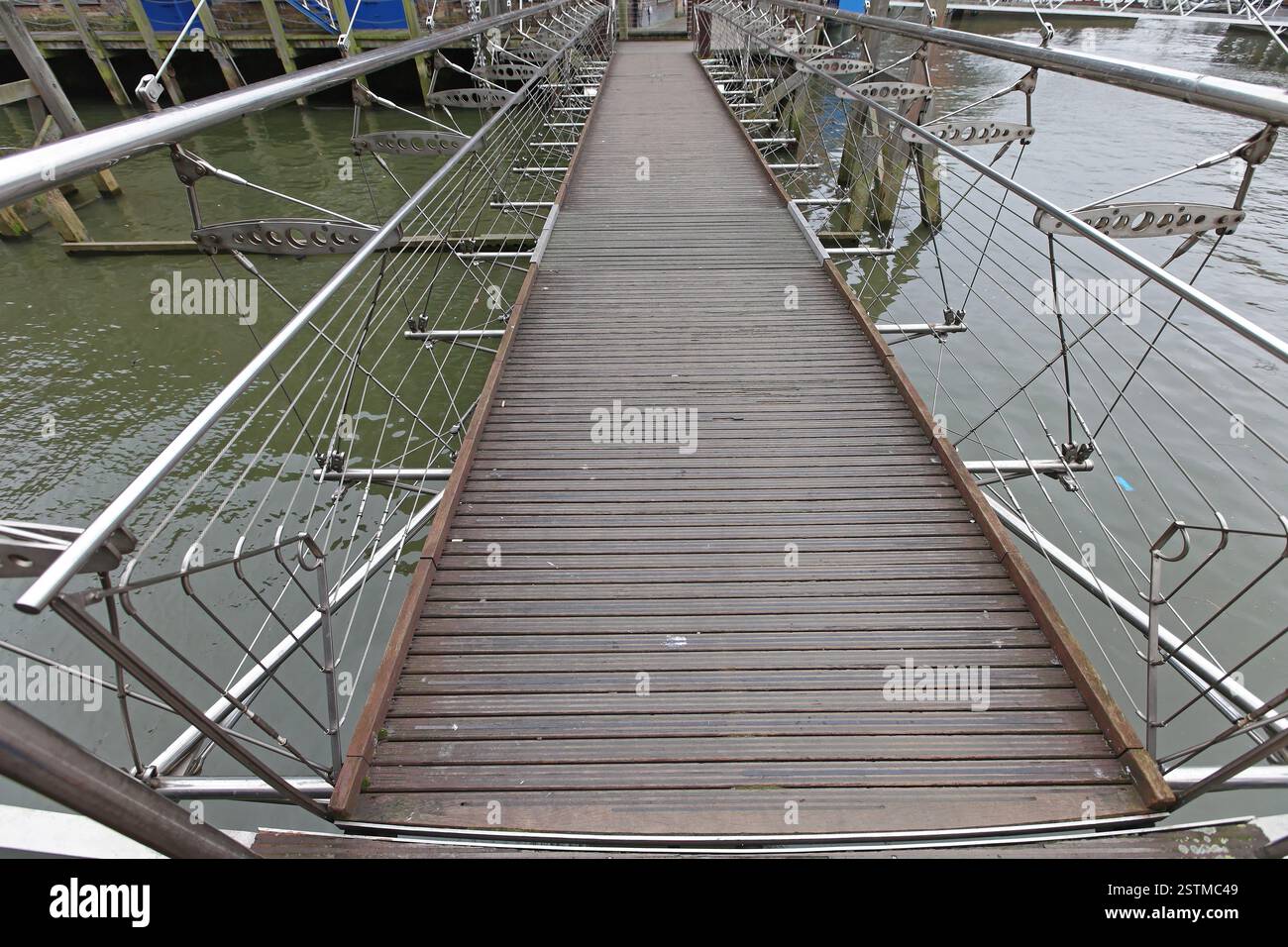 Suspension bridge for pedestrians over canal water hi-res stock ...