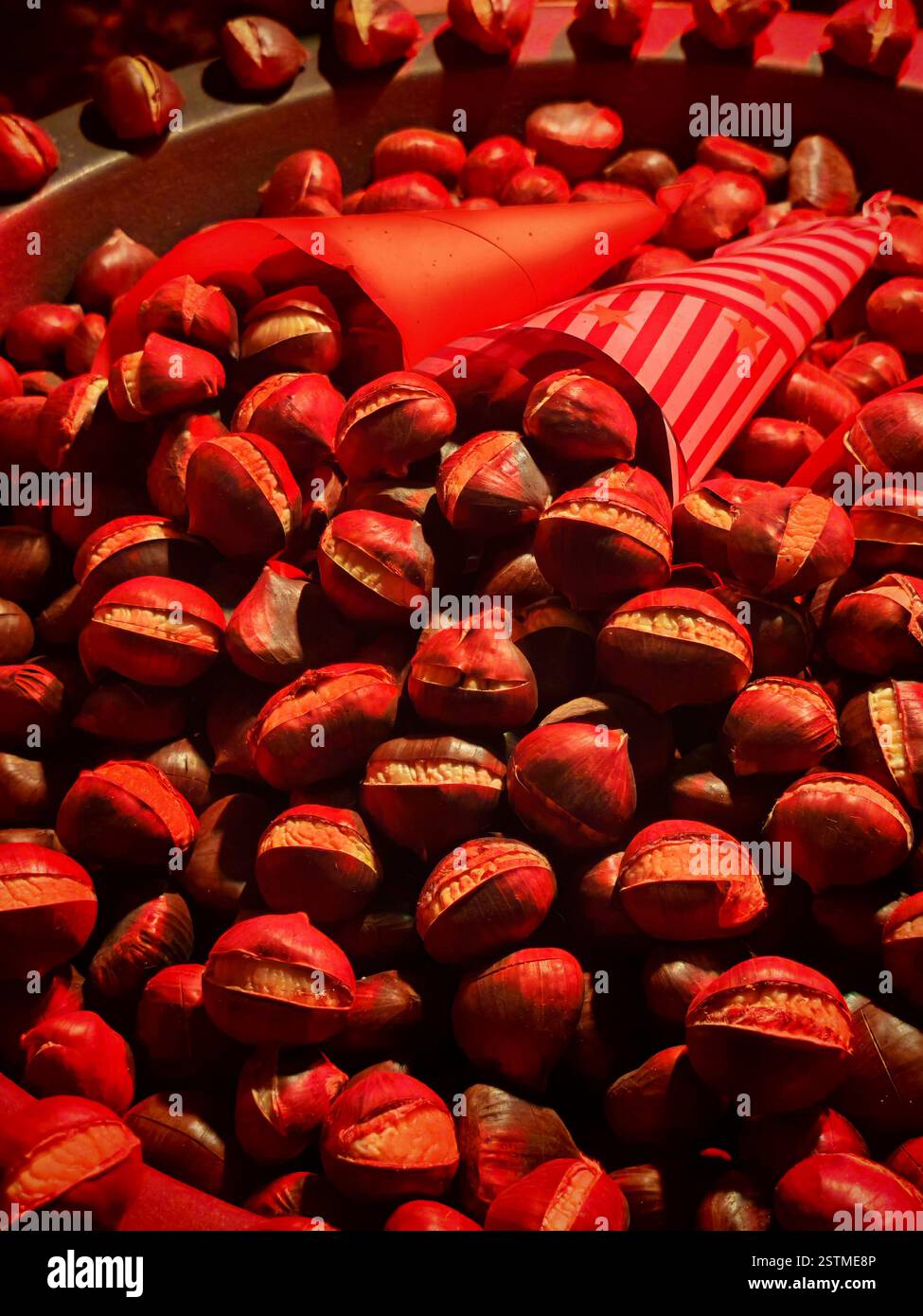 a chestnut vendor roasting chestnuts, delicious edible nuts with brown ...