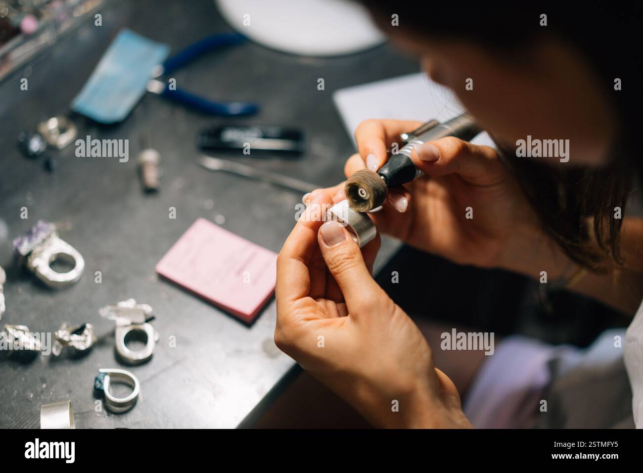 The girl works on a jewelry in the workshop Stock Photo - Alamy