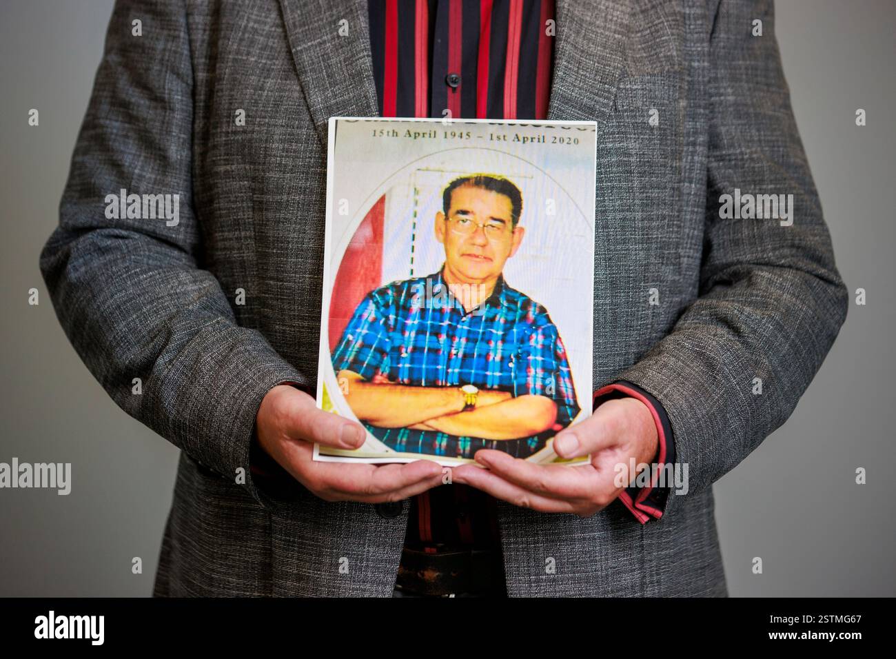 Trevor Patterson holds an image of his late brother Samuel Patterson at ...