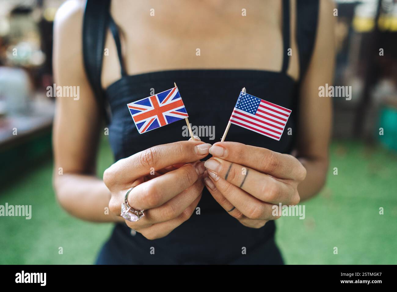 Female hands hold small flags of two countries Stock Photo - Alamy