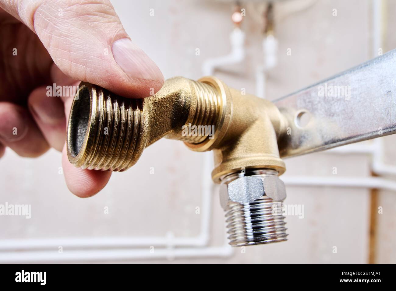 Brass elbow fitting with an internal threaded connection is being ...