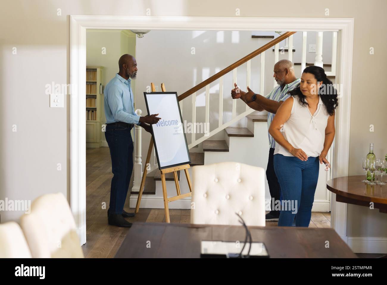 Preparing welcome sign for celebration, African American couple feeling ...
