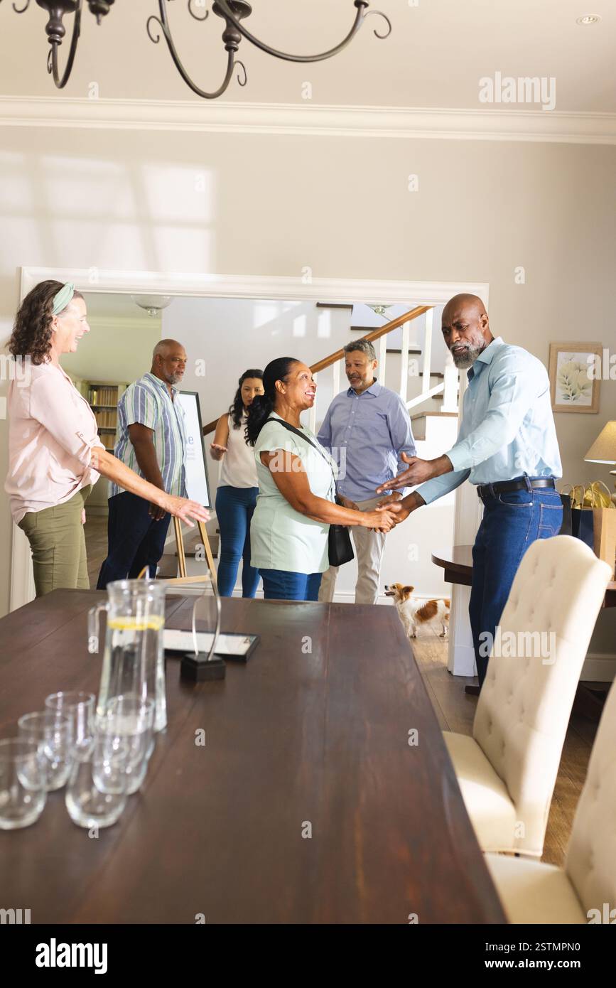 Family gathering at home, seniors warmly greeting guests with smiles ...