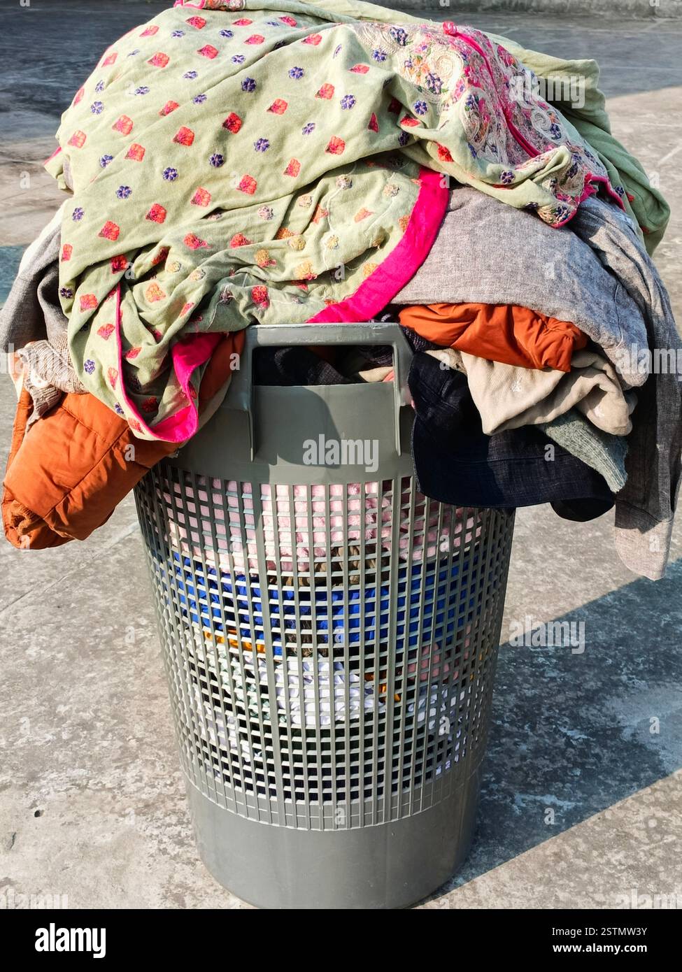 a laundry basket full of clothes ready for washing Stock Photo - Alamy