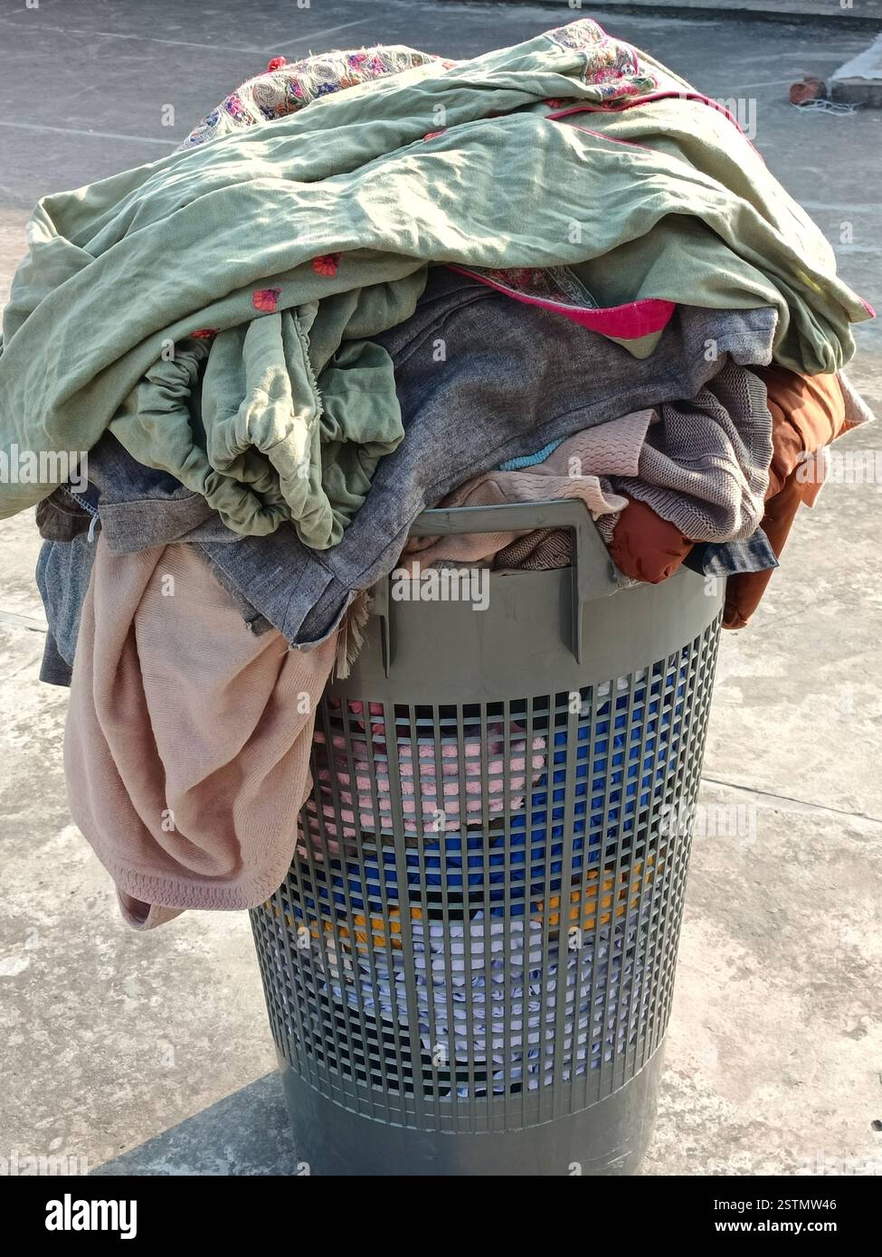 a laundry basket full of clothes ready for washing Stock Photo - Alamy