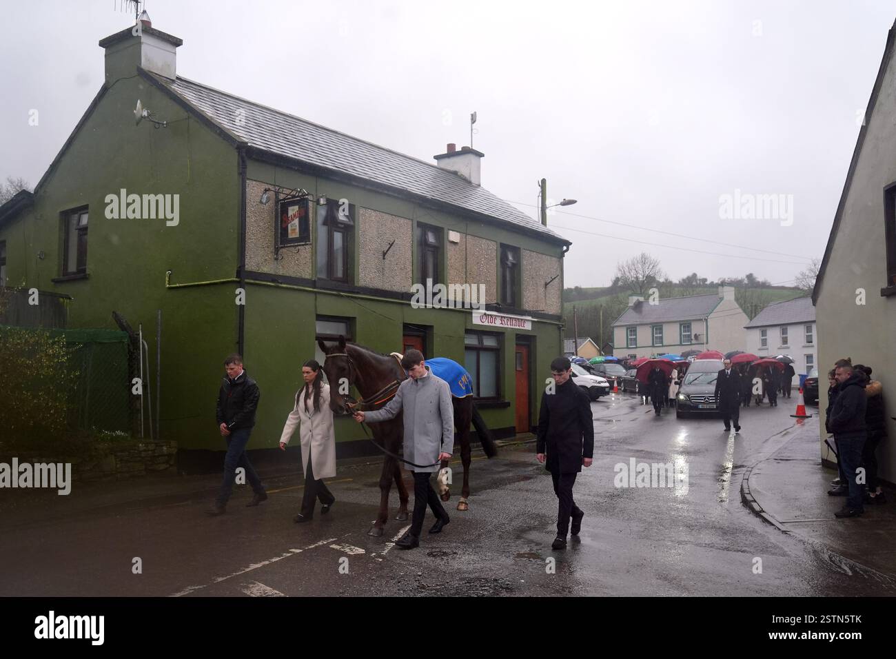 The hearse carrying the coffin of Michael O'Sullivan is lead by a horse ...