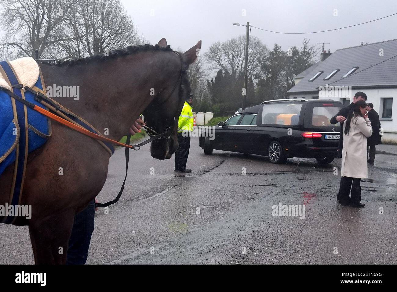 The hearse carrying the coffin of Michael O'Sullivan is lead by a horse ...