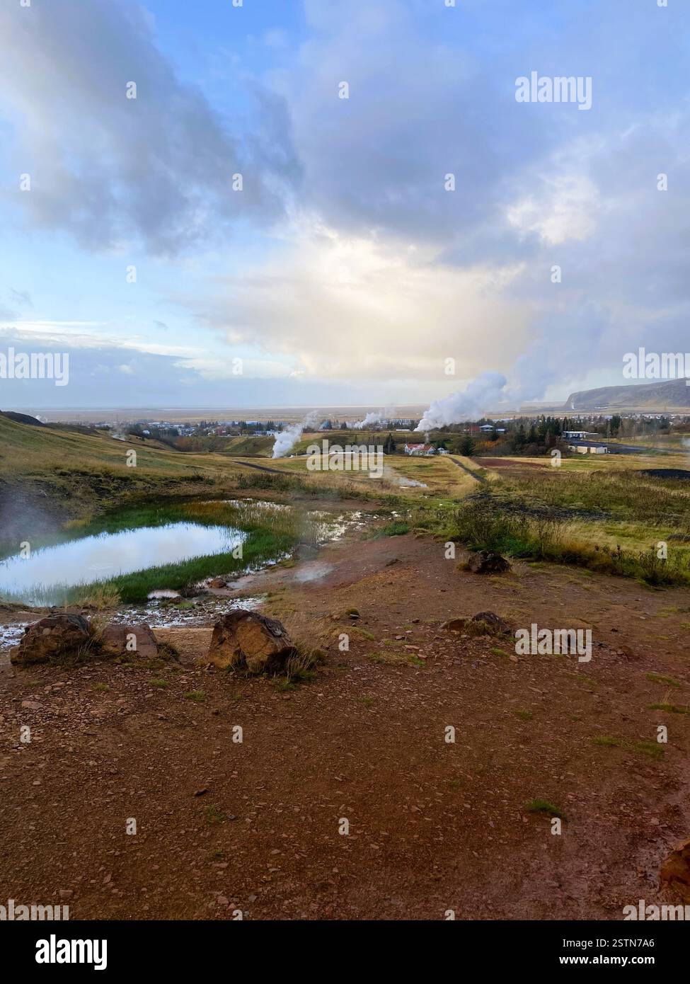 The photo captures a captivating geothermal landscape with a tranquil ...