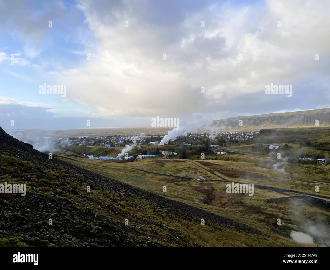 The photo showcases a stunning Icelandic landscape with a rocky slope ...