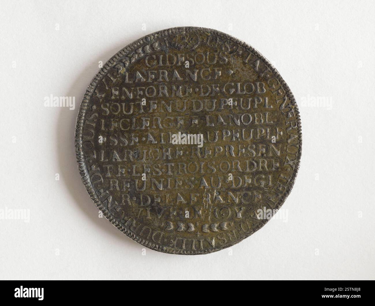A coin minted in 1789 showing a peasant from the Third Estate bearing ...