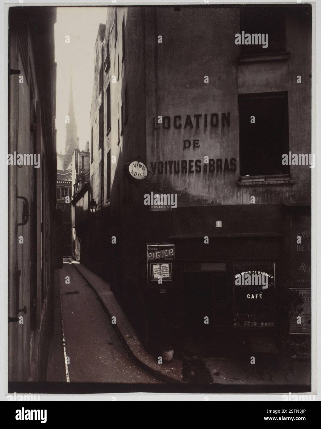 Eugène Atget’s 1923 photograph captures a street corner in Paris, with ...