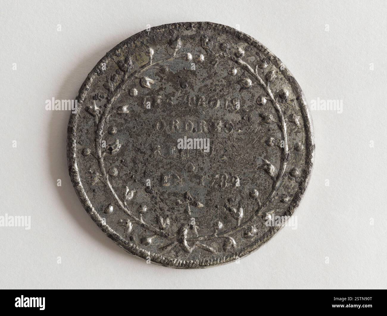A 1789 coin showing a peasant from the Third Estate shouldering the ...