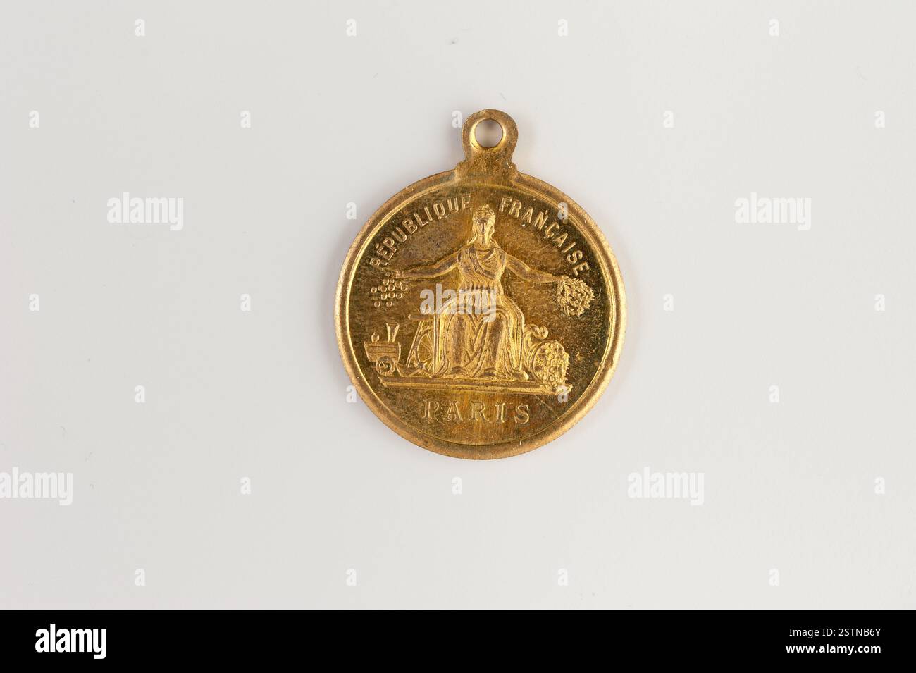 This 1878 medal portrays the Republic of France seated on a throne ...