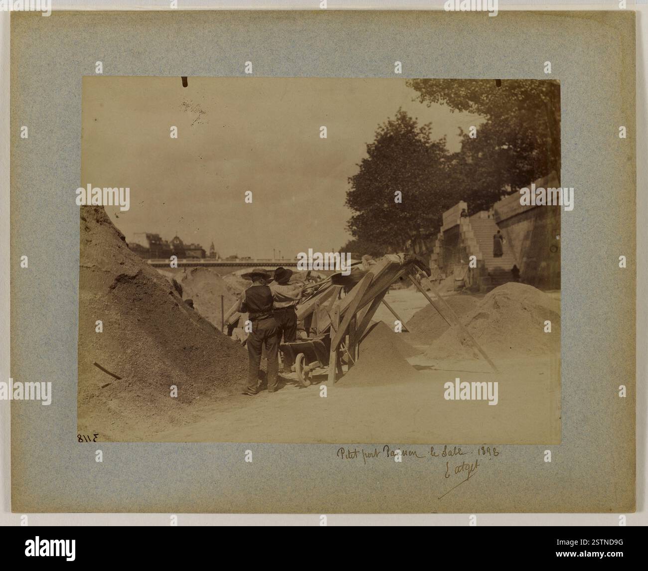 A photograph capturing a small port in Paris, showing workers on the ...