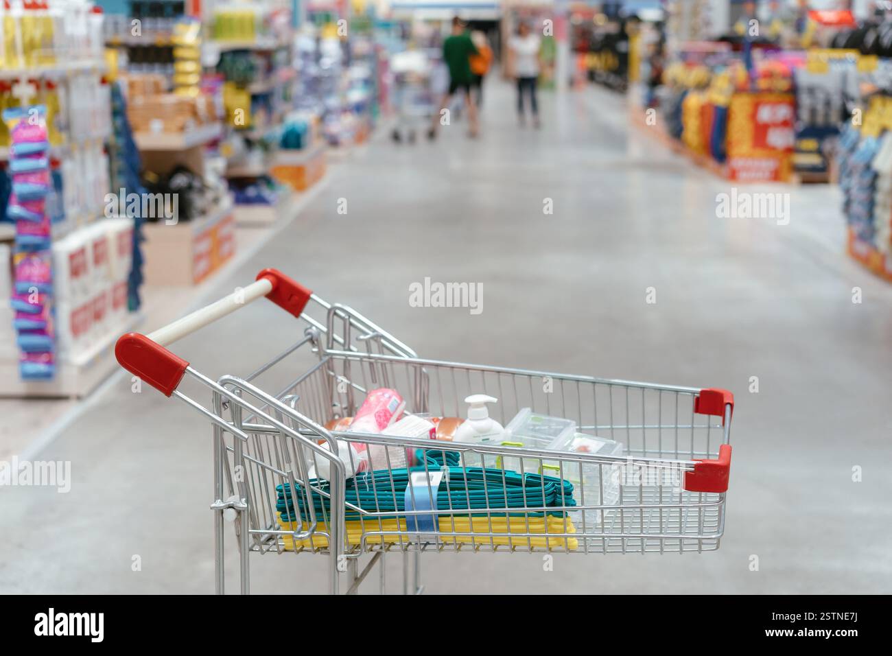 Trolley in a supermarket with various goods Stock Photo - Alamy