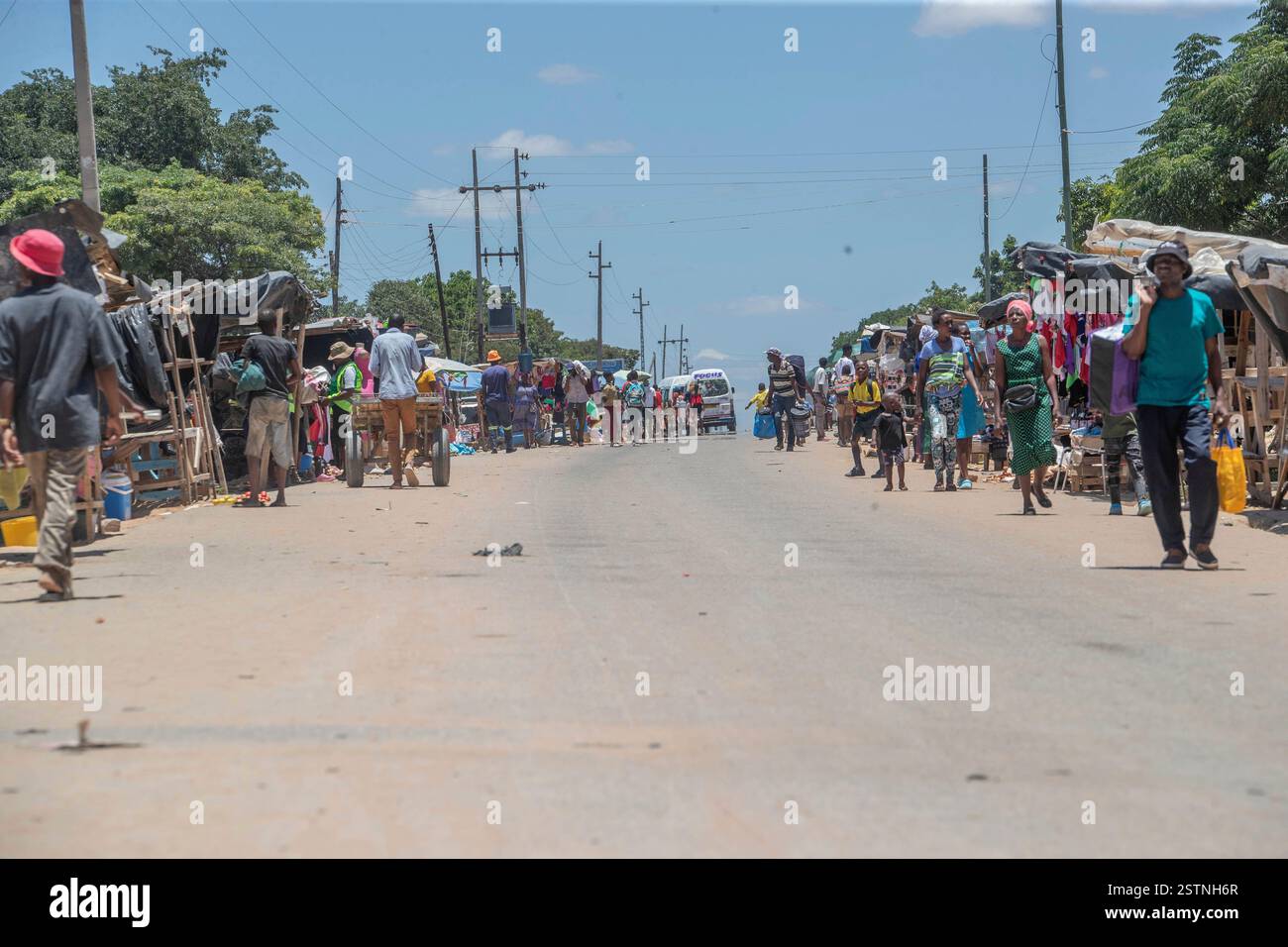 Residents walk in the Epworth neighbourhood of Harare, Zimbabwe, Friday ...