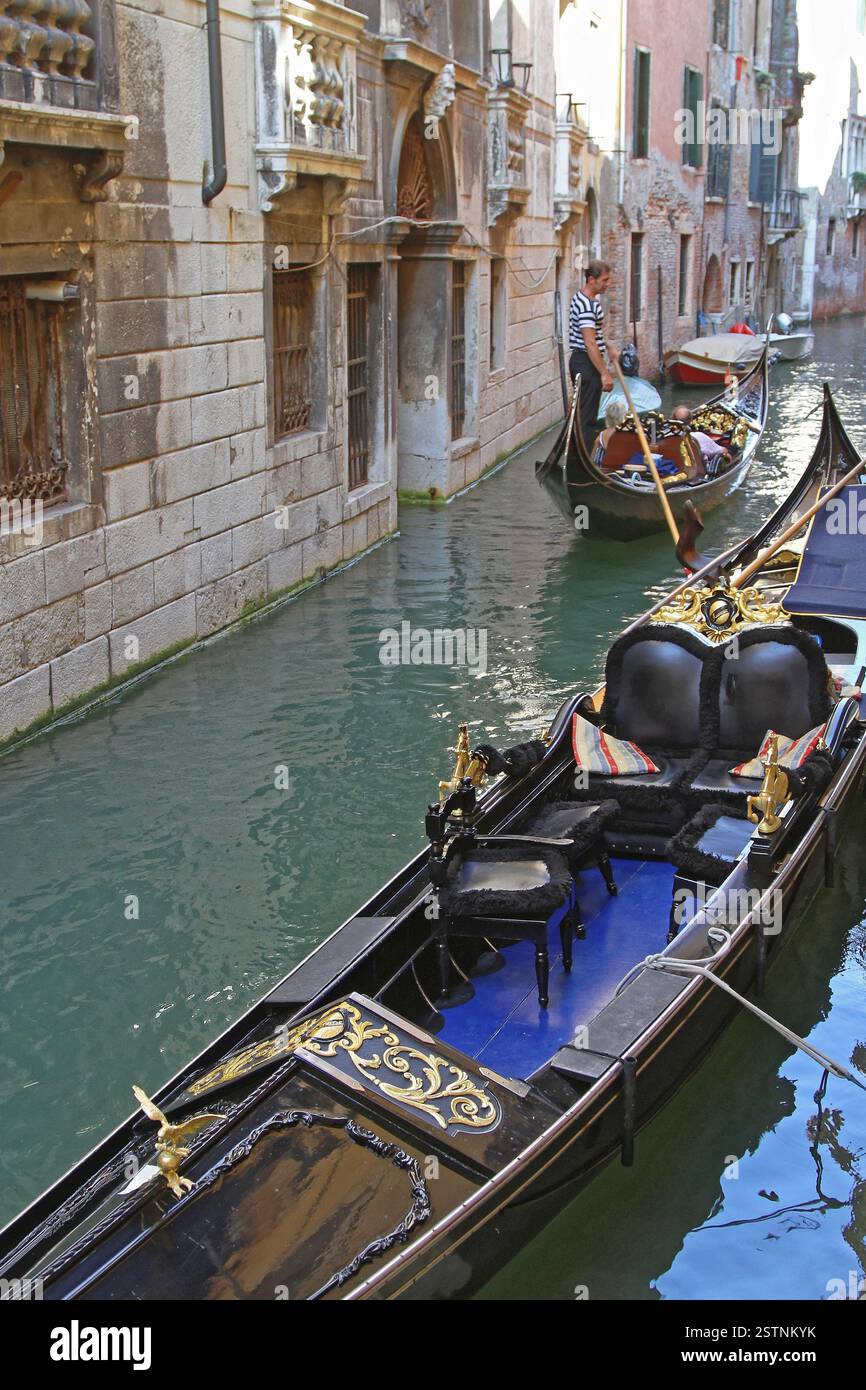 Traditional long gondola boat at narrow canal in venice hi-res stock ...