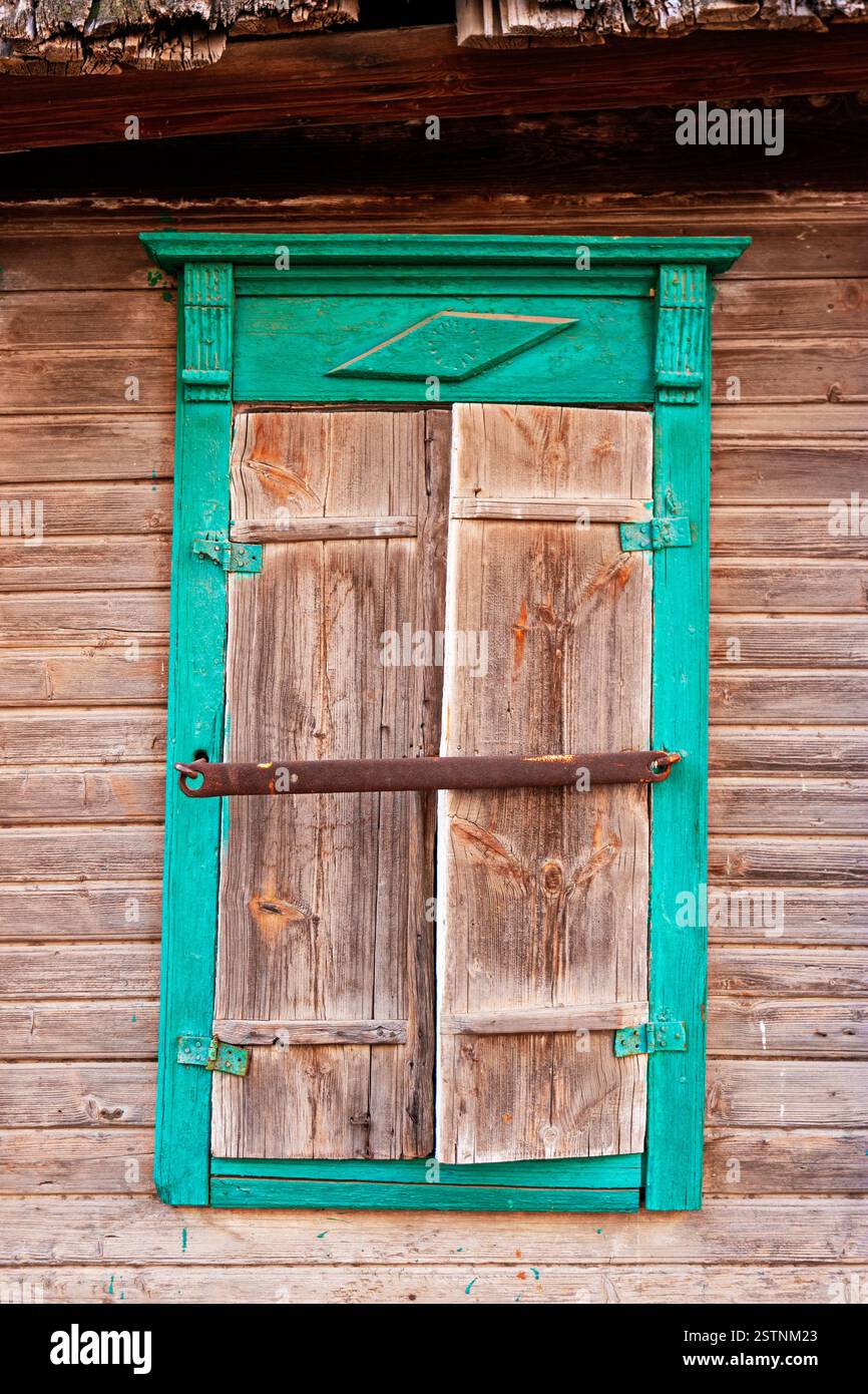 Closed shutters of carved window of wooden house in old russian style ...