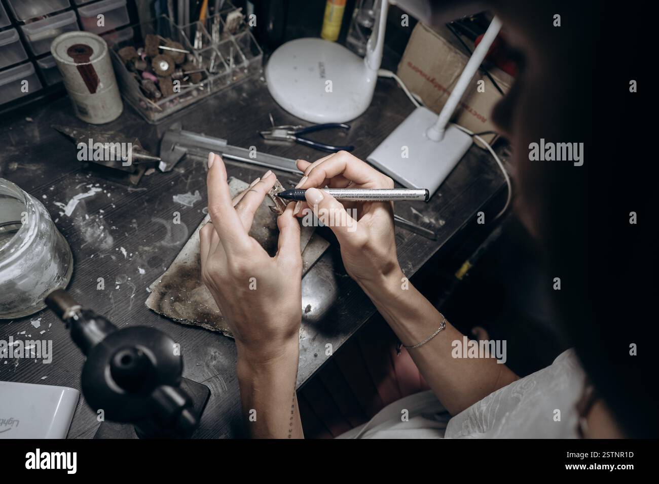 The master jeweler applies markup to the jewelry Stock Photo - Alamy