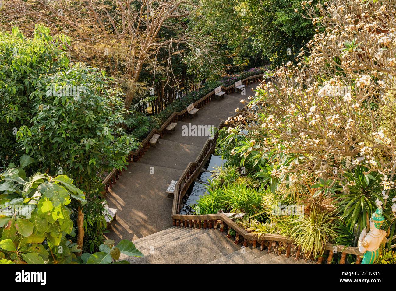 Winding concrete pathway with stone balustrades at Kao Hua Jook Pagoda ...