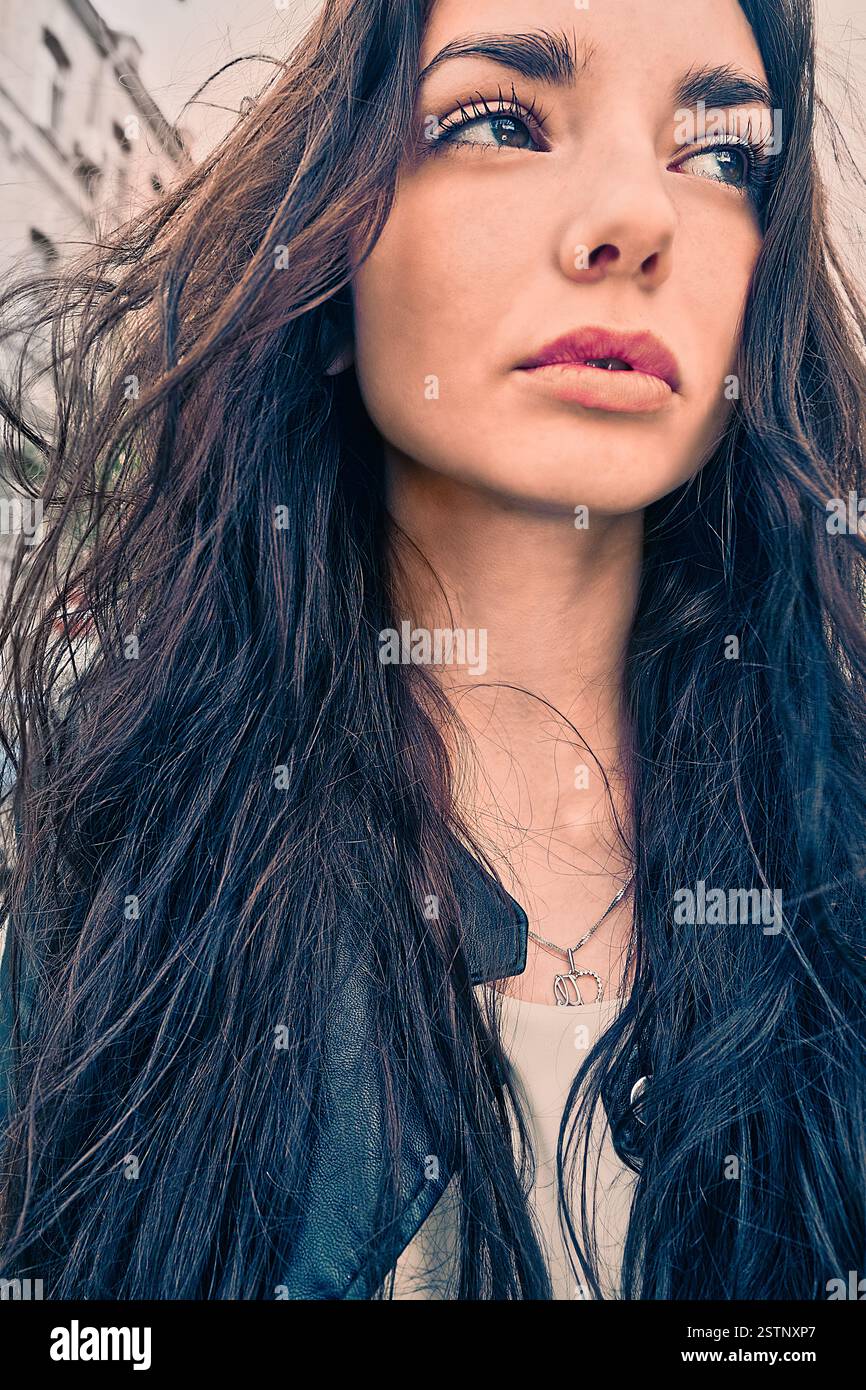Sad girl with pretty face and windy hair with her eyes looking up Stock Photo - Alamy