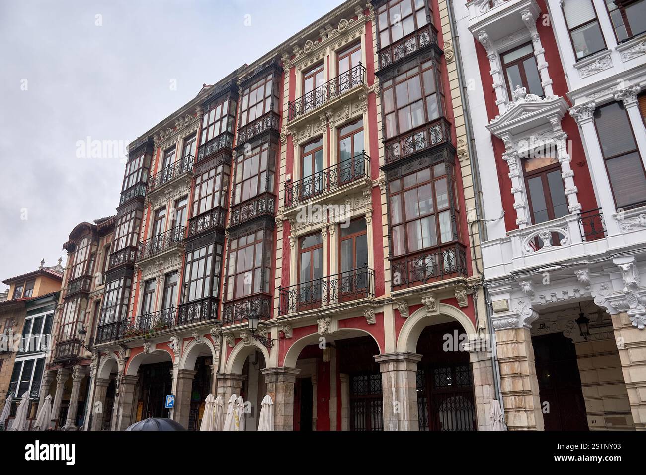 The colorful facades of historic buildings in the old town of Avilés ...
