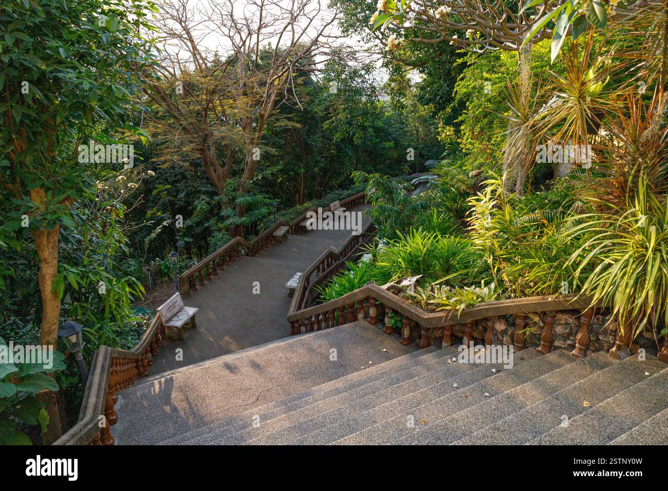 Winding concrete pathway with stone balustrades at Kao Hua Jook Pagoda ...