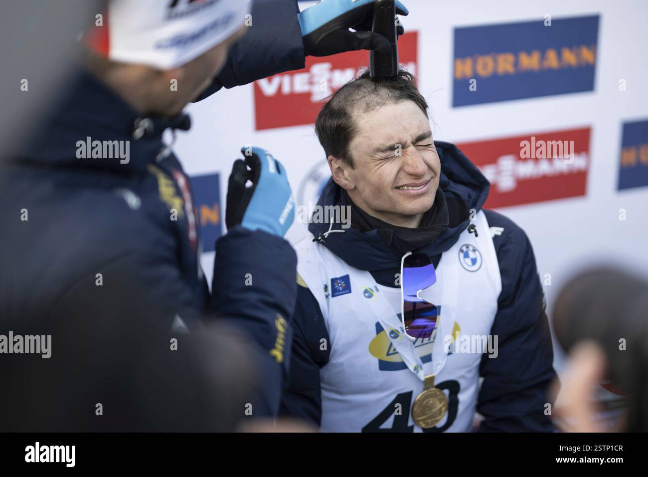 Gold medalist Eric Perrot of France has his head shaven after the men's ...