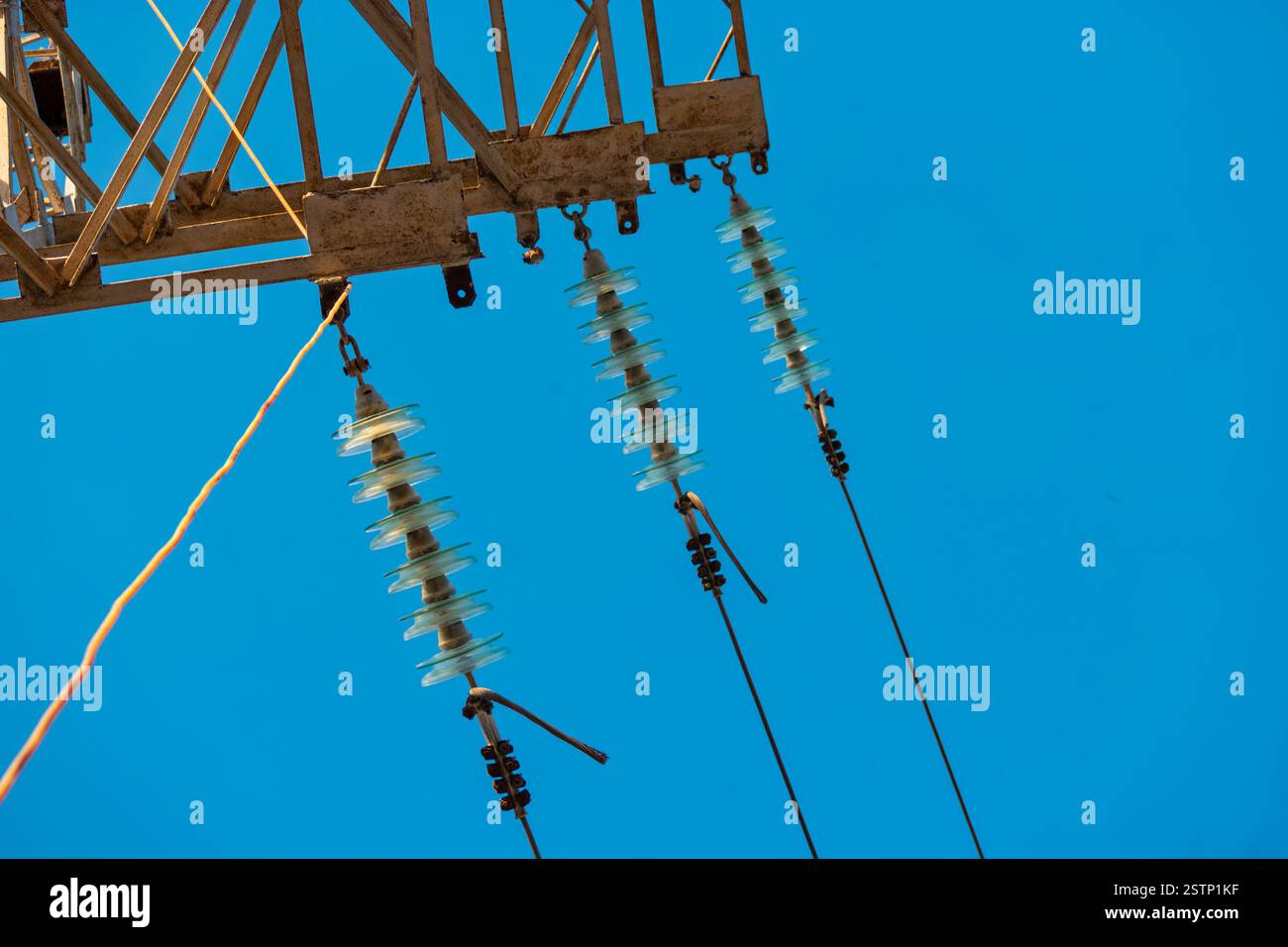 Power tower detail with three row od glass insulators and the wires in ...