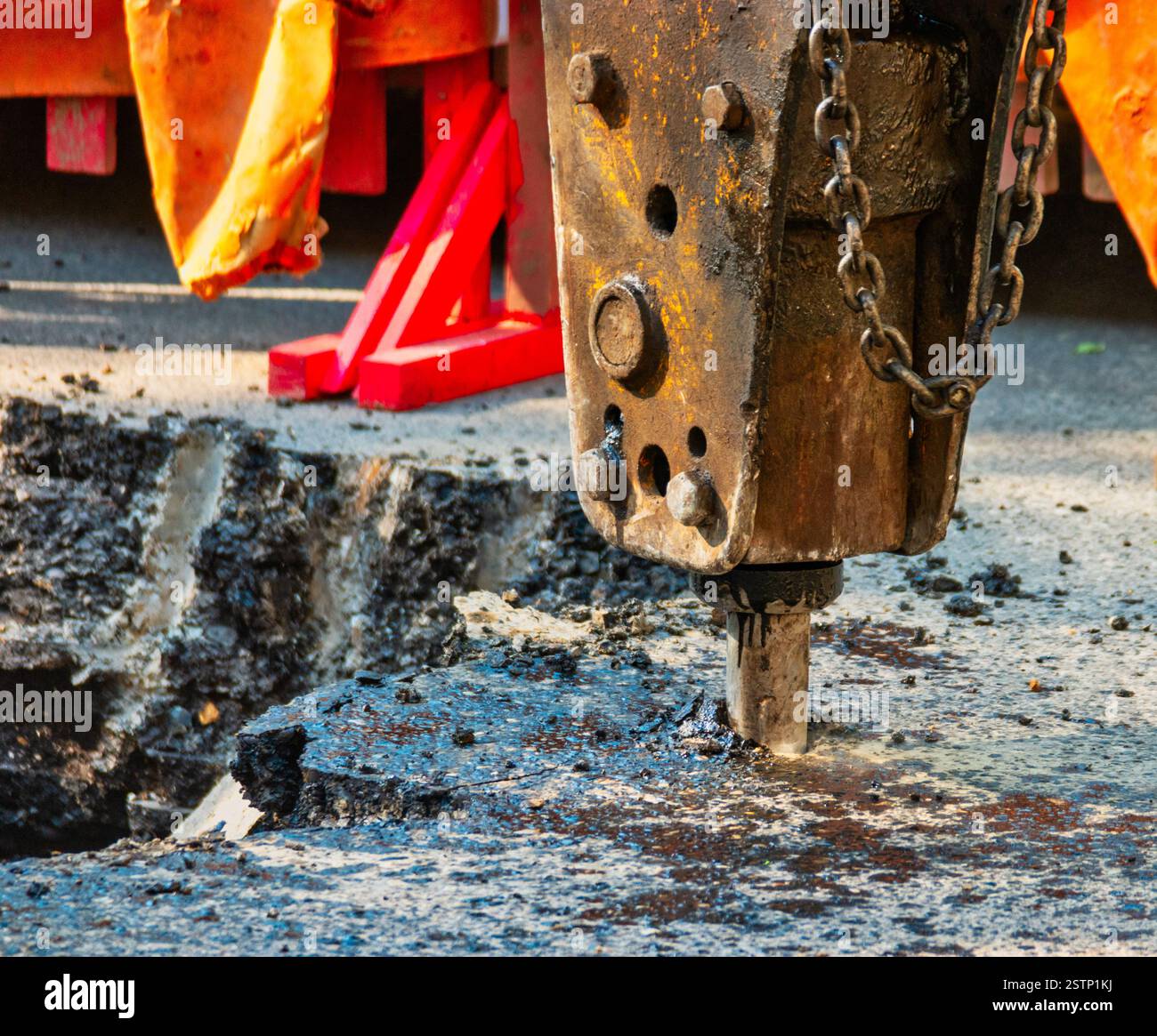Rusty pneumatic destroyer working on asphalt surface - repairment works ...