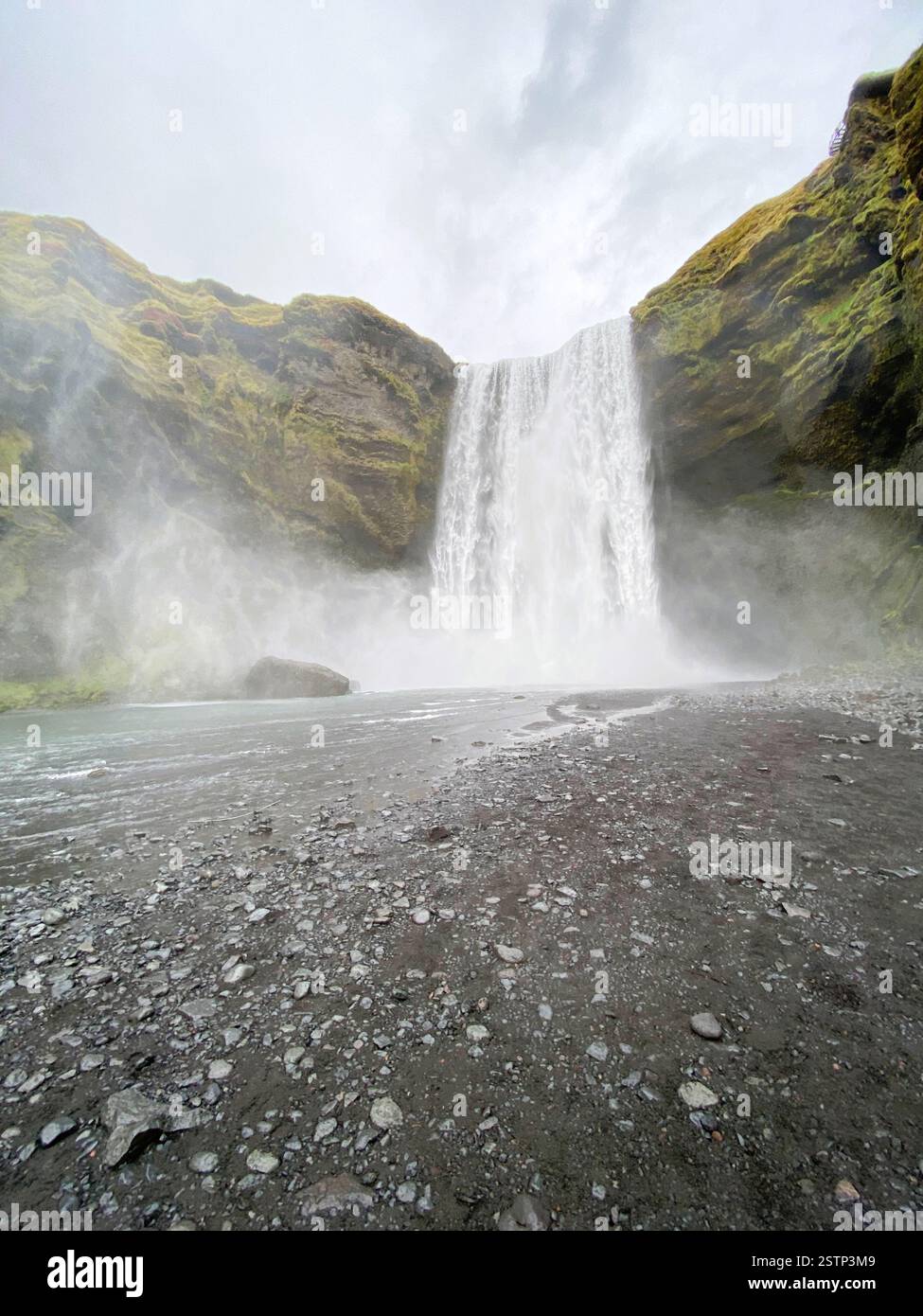 The image depicts a breathtaking waterfall, likely Seljalandsfoss in ...